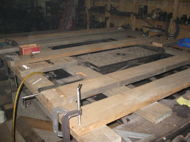 aw$ Bolting together pieces of the water tank support frame fitted in place